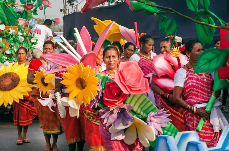 Women participating and performing with flowers as prop in Goa Carnival ...