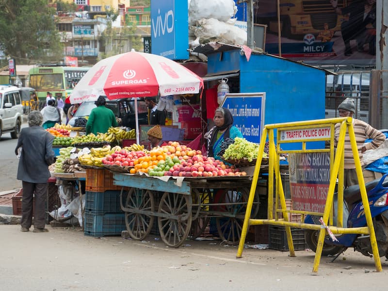 Local woman managing outdoor stand at Ooty's main market